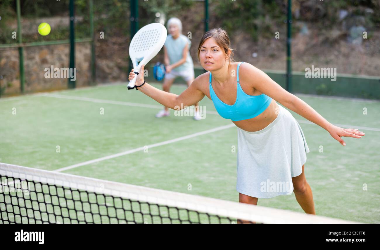 Attractive woman padel tennis player training on court Stock Photo - Alamy