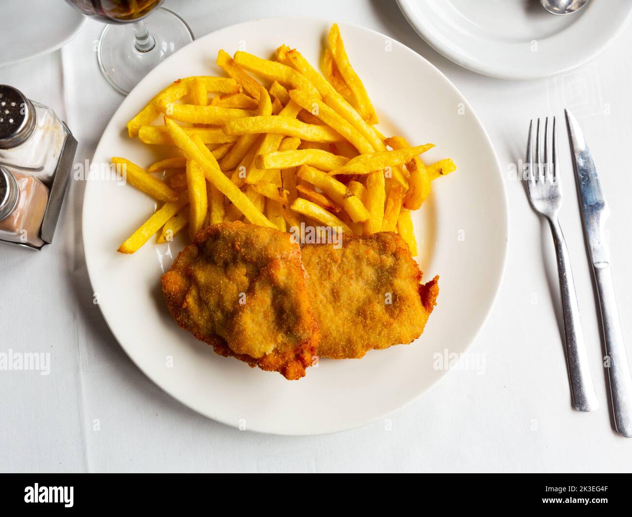 Roasted breaded pork fillet with fried potatoes for dinner Stock Photo ...