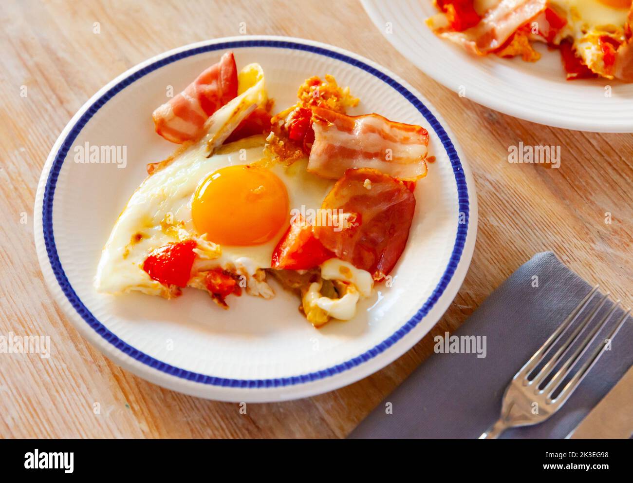 Bacon with fried potato and egg served on plate on table Stock Photo ...
