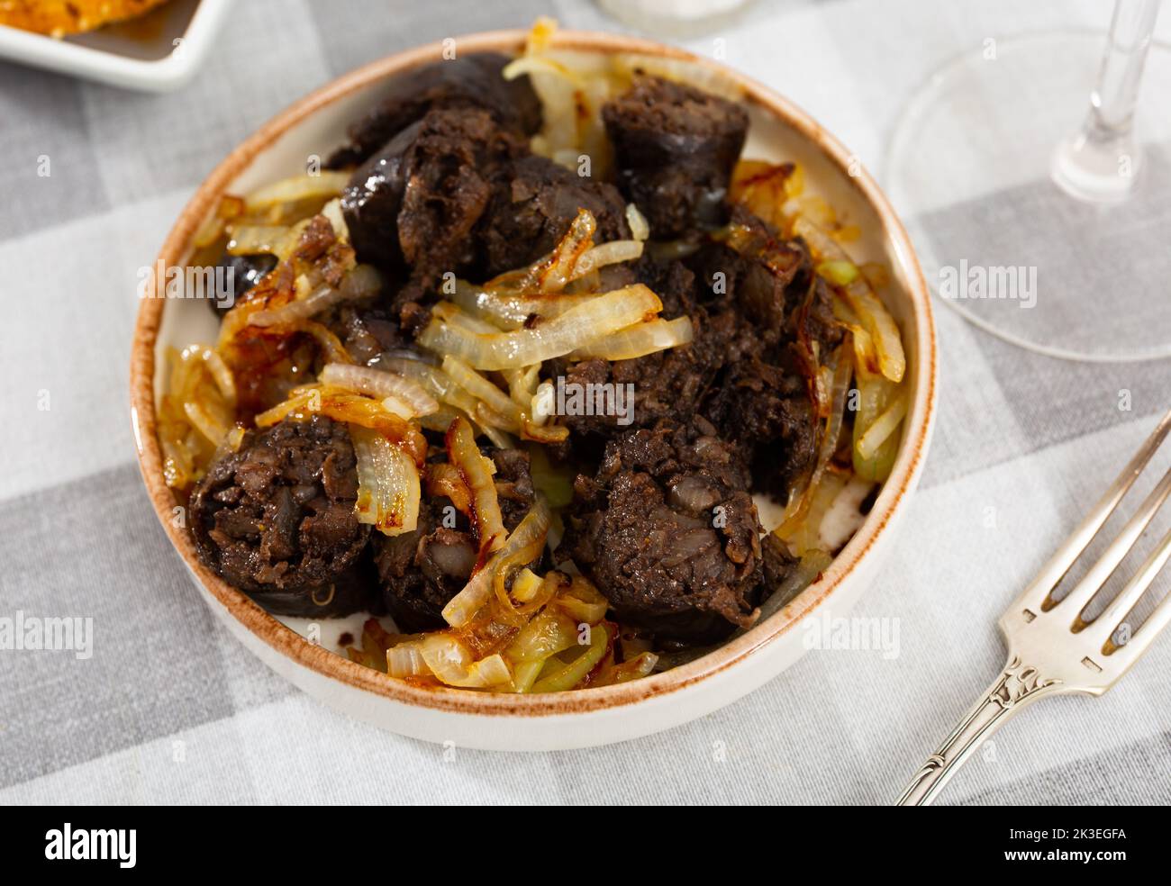Morcilla con cebolla - fried blood sausage with onion on table Stock ...