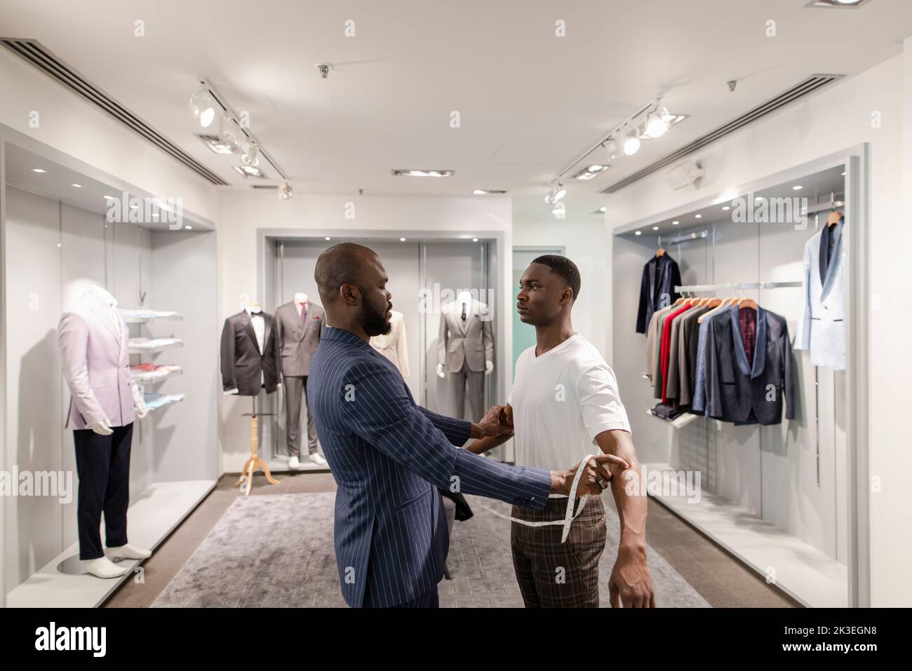 Black suit fitting hi-res stock photography and images - Alamy