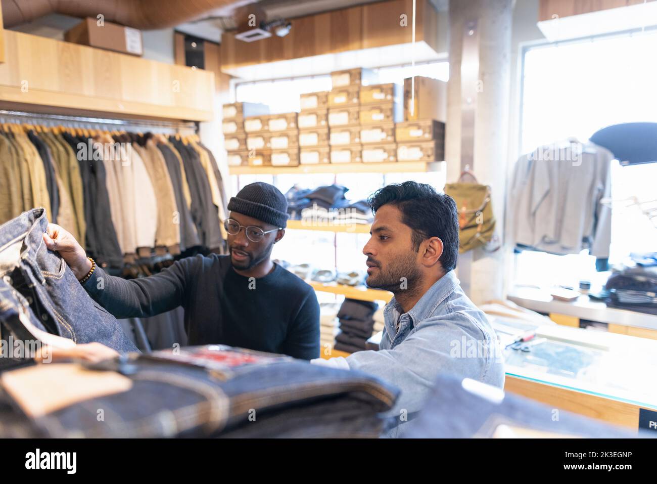 Clothing store owner helping customer hi-res stock photography and ...