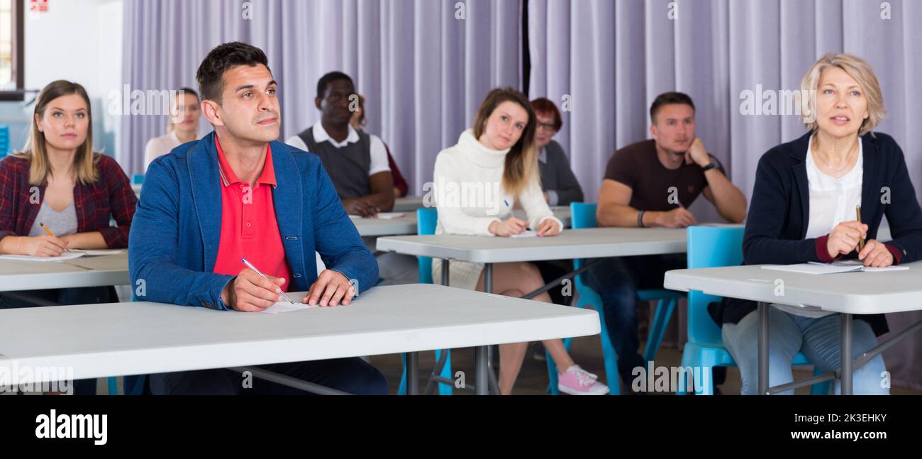 Adult students listening in classroom Stock Photo - Alamy