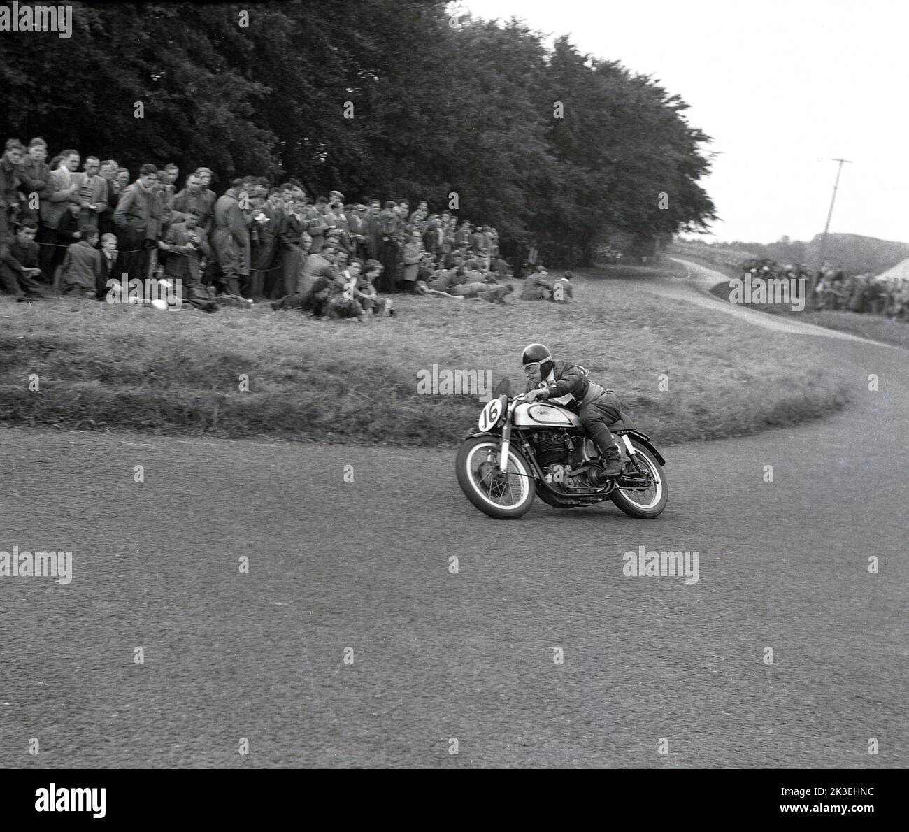 1954, historical, in a wooded section of a forest, spectators on a ...