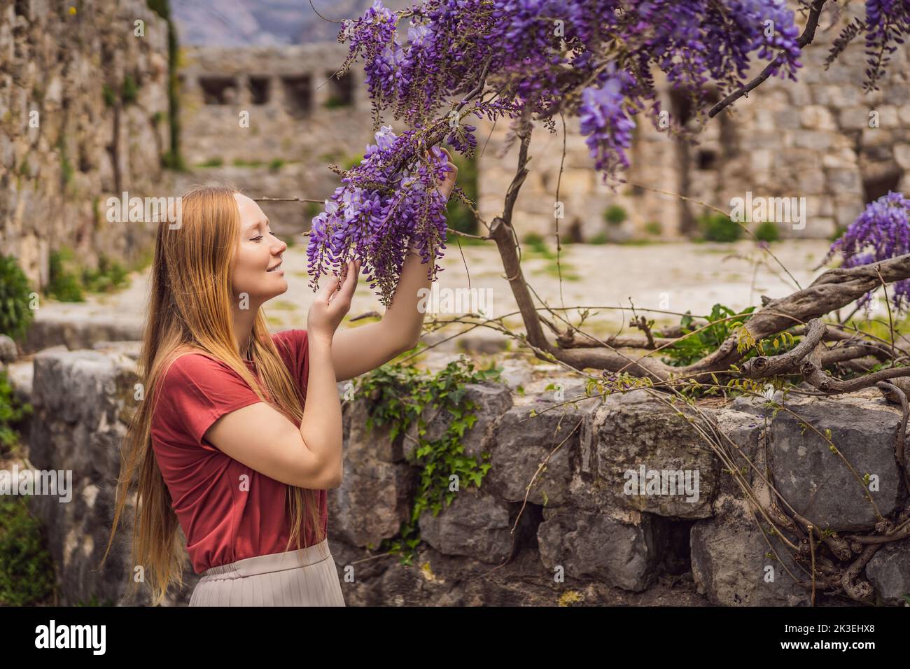Woman tourist walks through the old town of Bar in Montenegro. Happy ...
