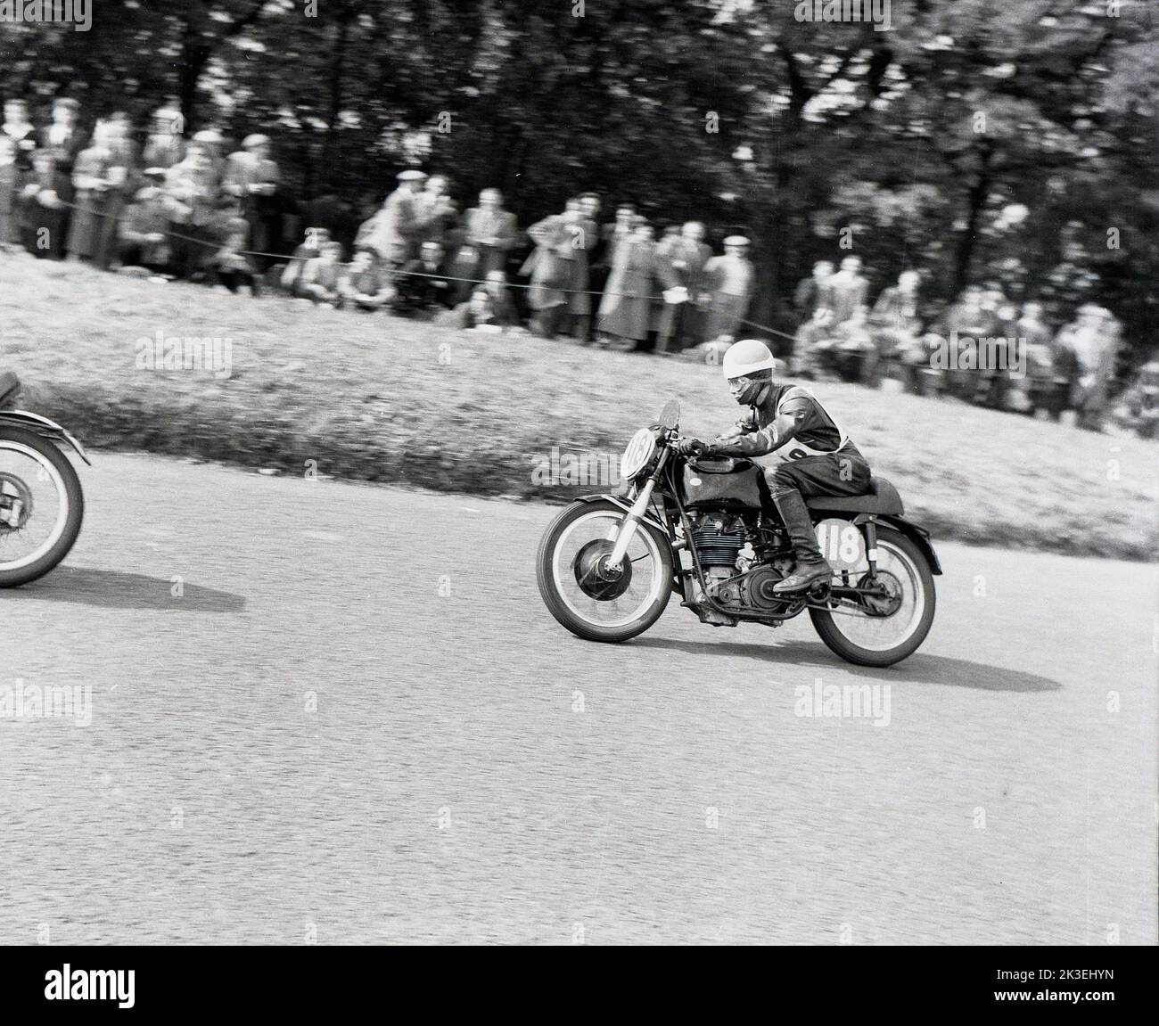 1954, historical, spectators watching a motorcycle racer on the course ...