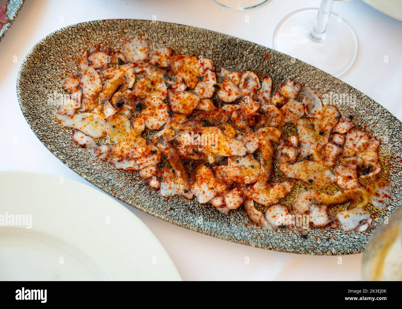 Popular dish of Italian cuisine is octopus carpaccio Stock Photo - Alamy