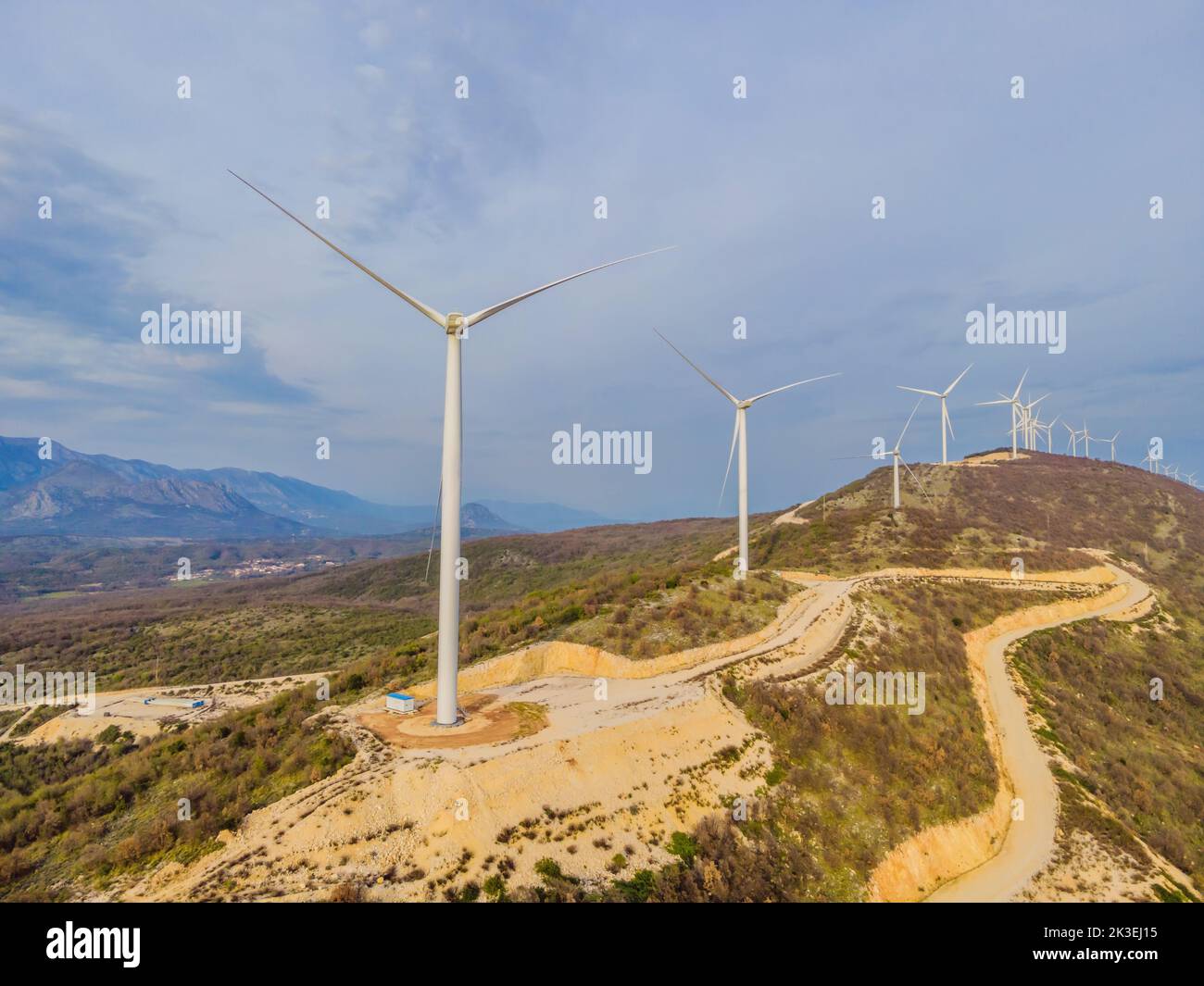 Wind turbines on beautiful sunny summer autumn mountain landsape. Curvy ...