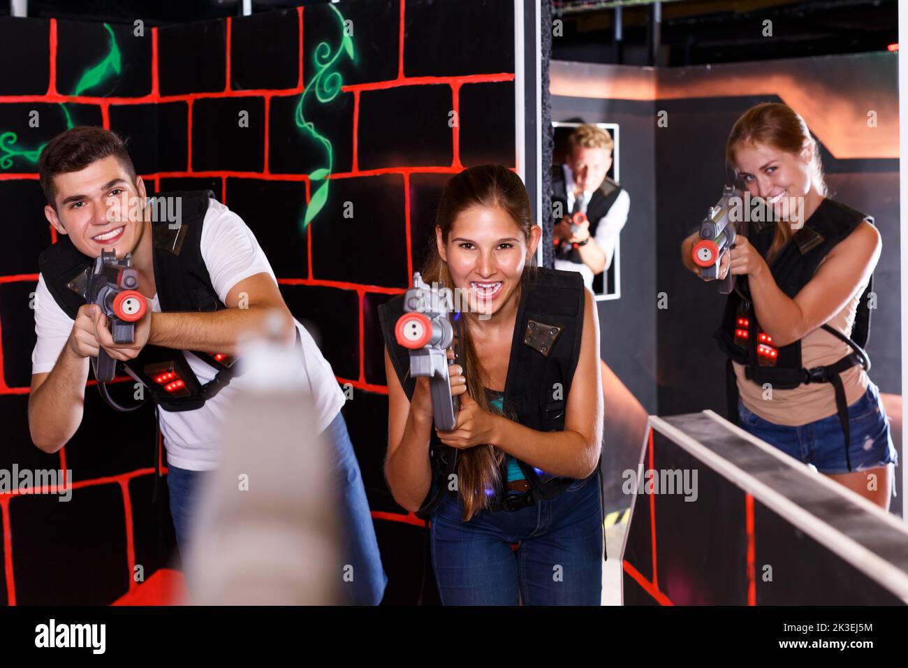 Young team playing laser tag game Stock Photo - Alamy