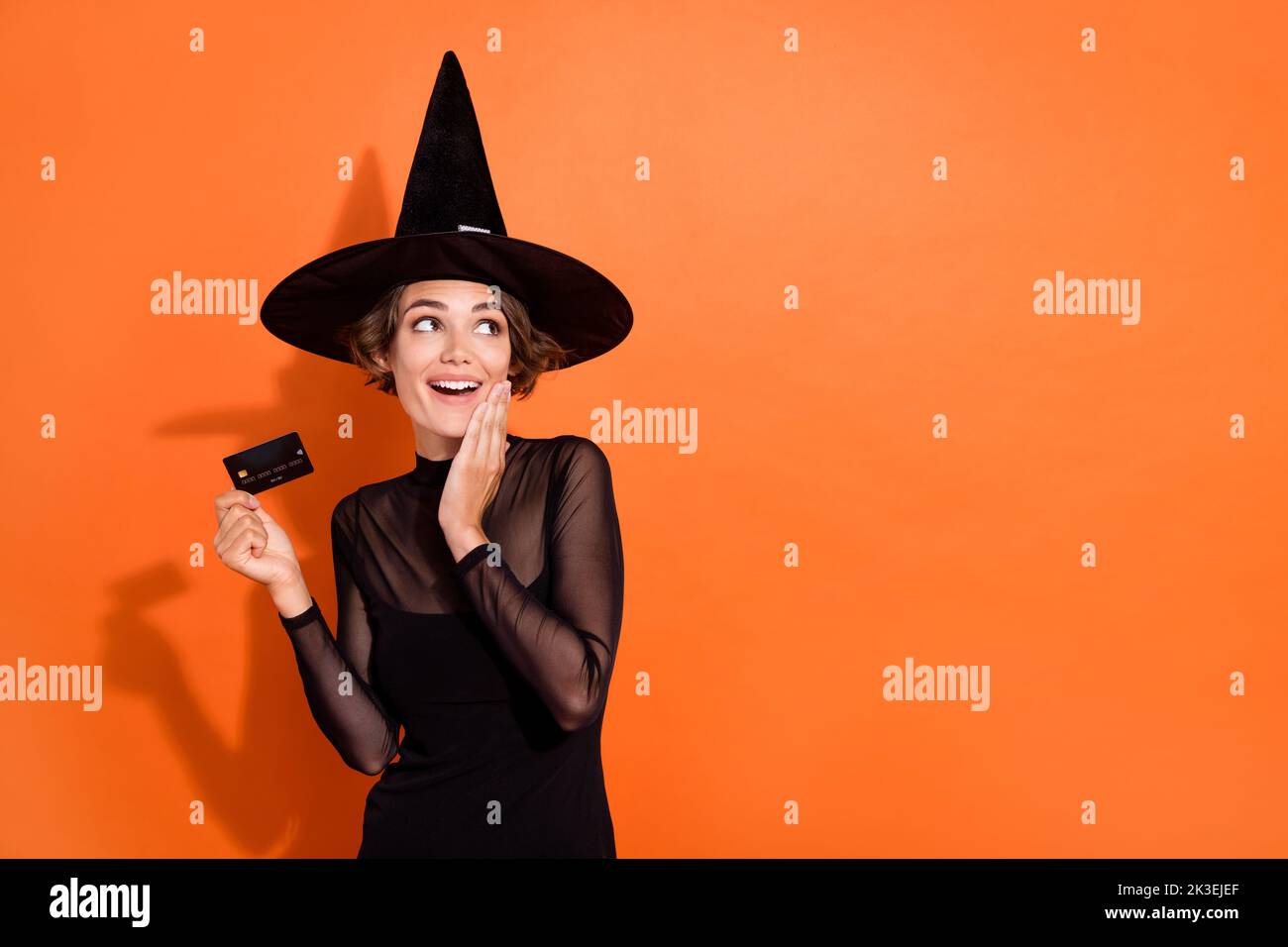 Portrait of astonished positive person arm touch cheek hold debit card ...