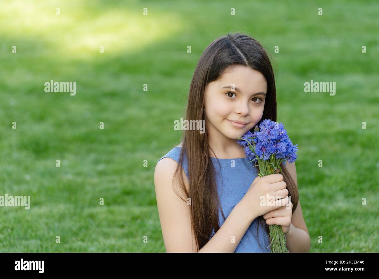 teen girl with flowers. pretty girl on grass. cute girl portrait. copy ...
