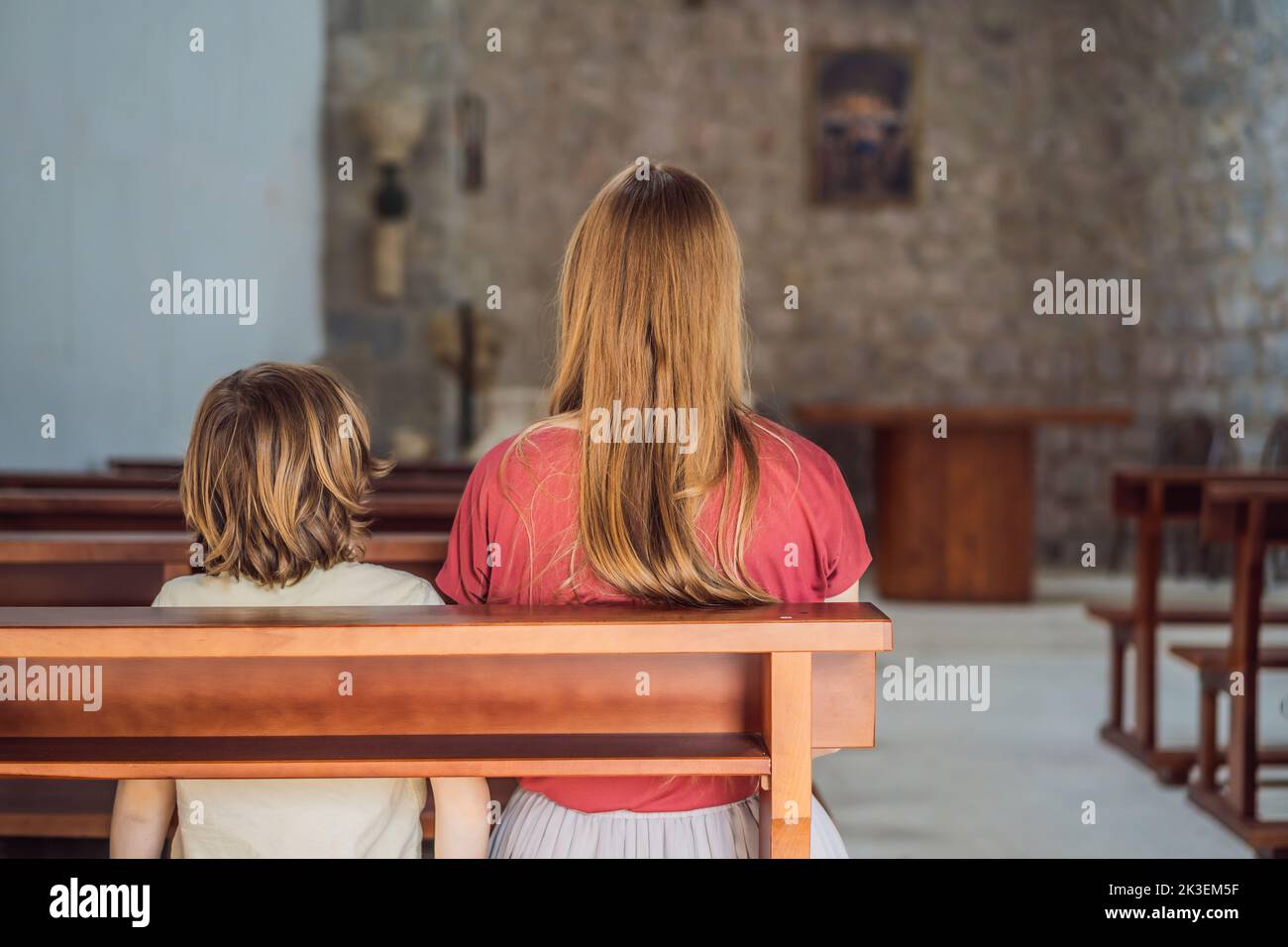 A Christian mom tells her son Bible stories about Jesus sitting in ...