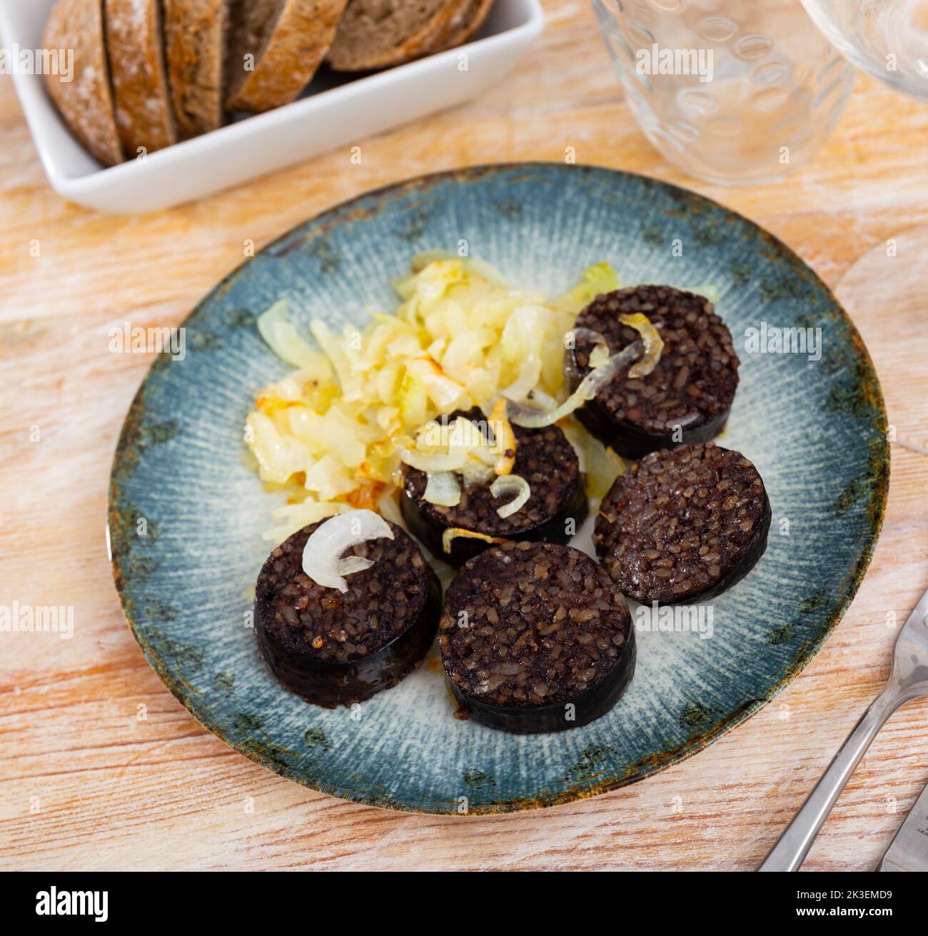 Spanish blood sausage morcilla served with grilled onion Stock Photo ...