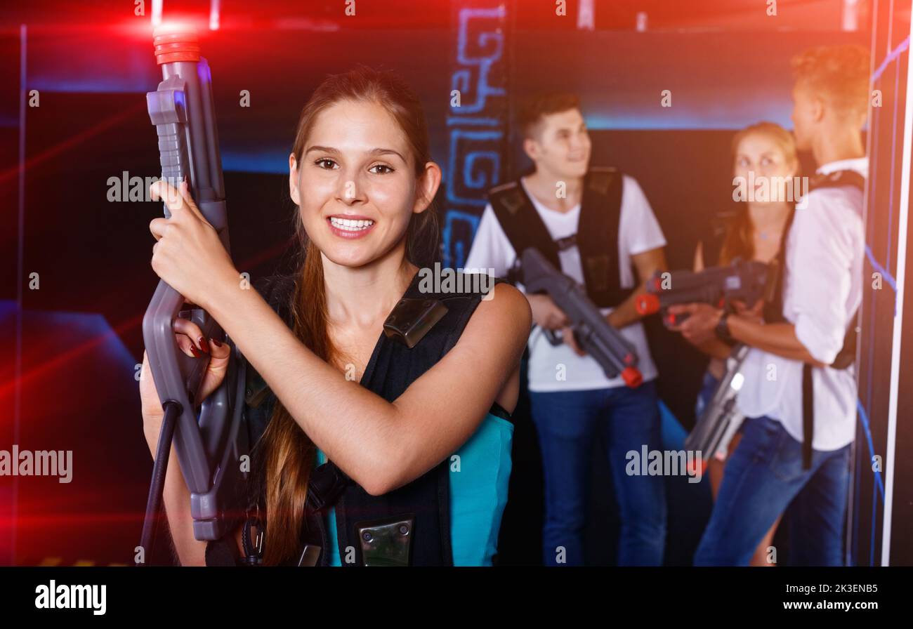 Portrait of exciting girl with laser pistol playing laser tag in Stock ...