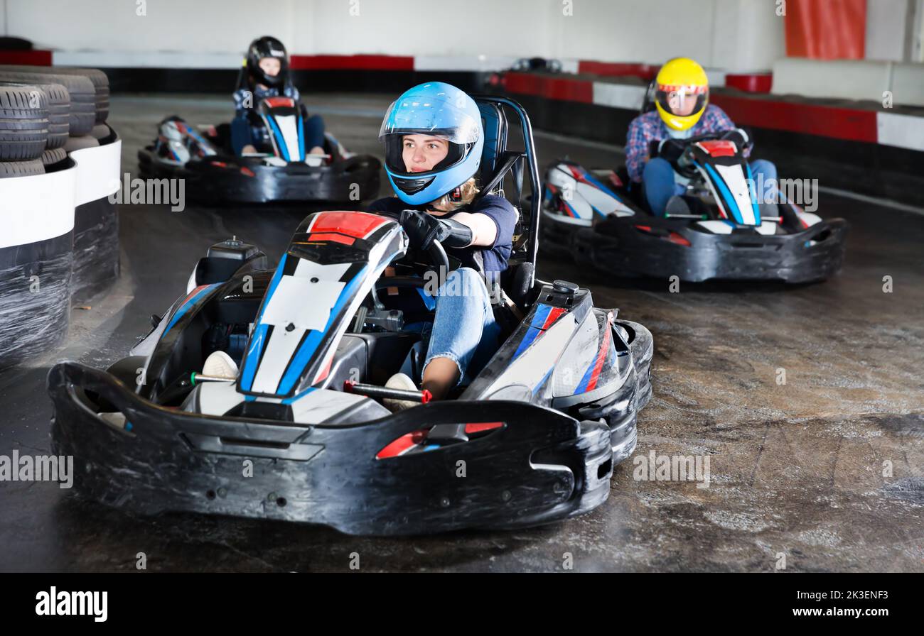 Female racer in helmet driving kart on track Stock Photo - Alamy