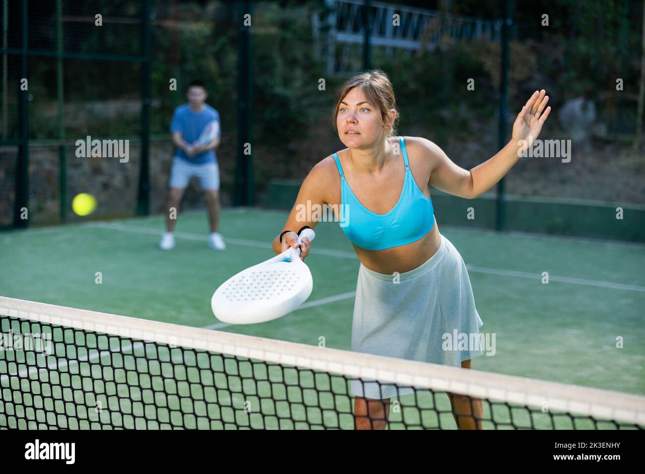 Fit young woman playing padel tennis on open court Stock Photo - Alamy