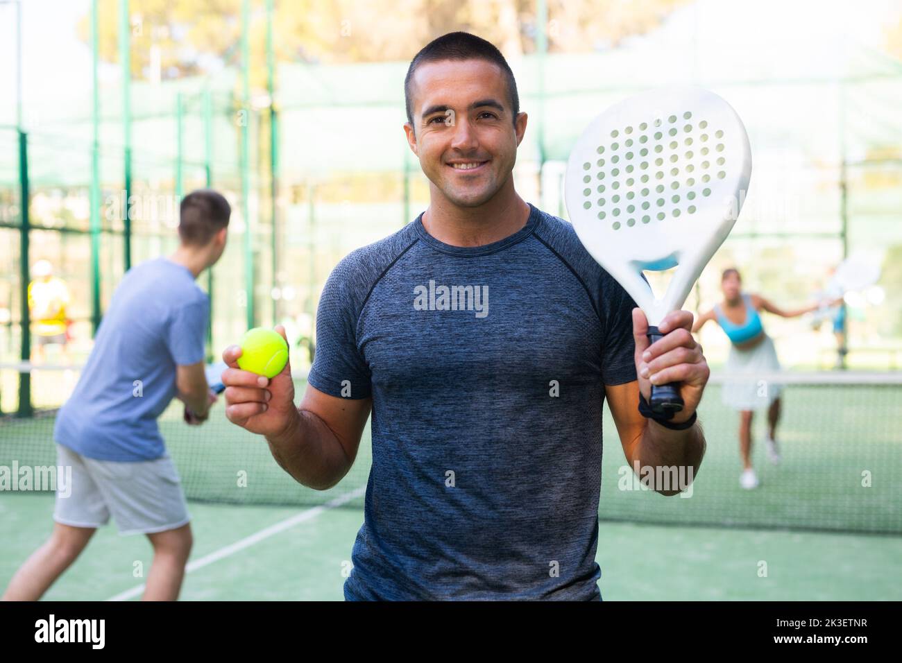 Portrait of positive man on padel tennis court Stock Photo - Alamy
