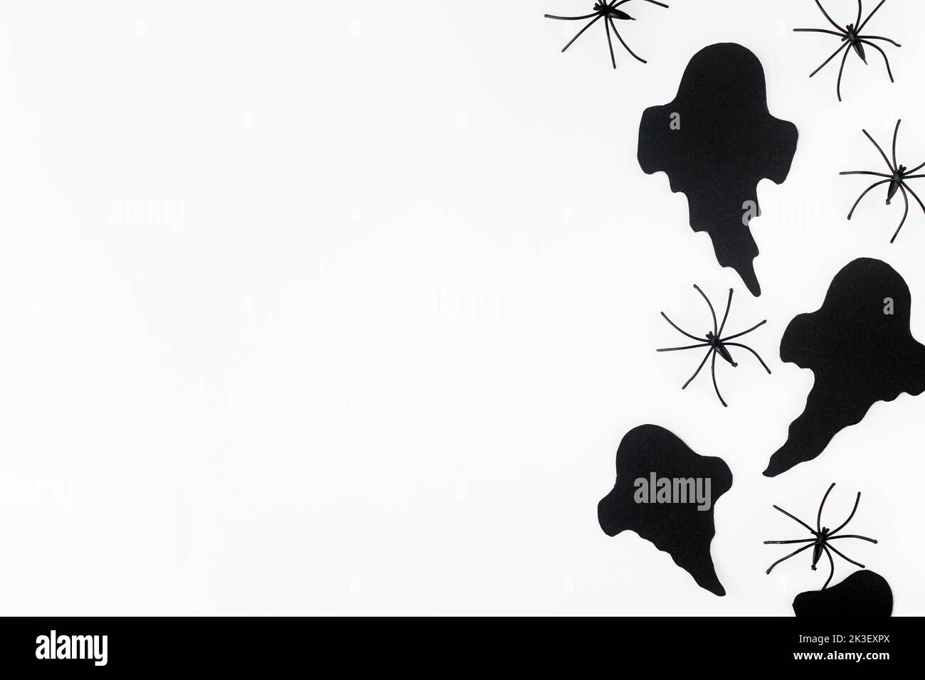 Halloween flat lay. Black ghosts and spiders decorations on white ...