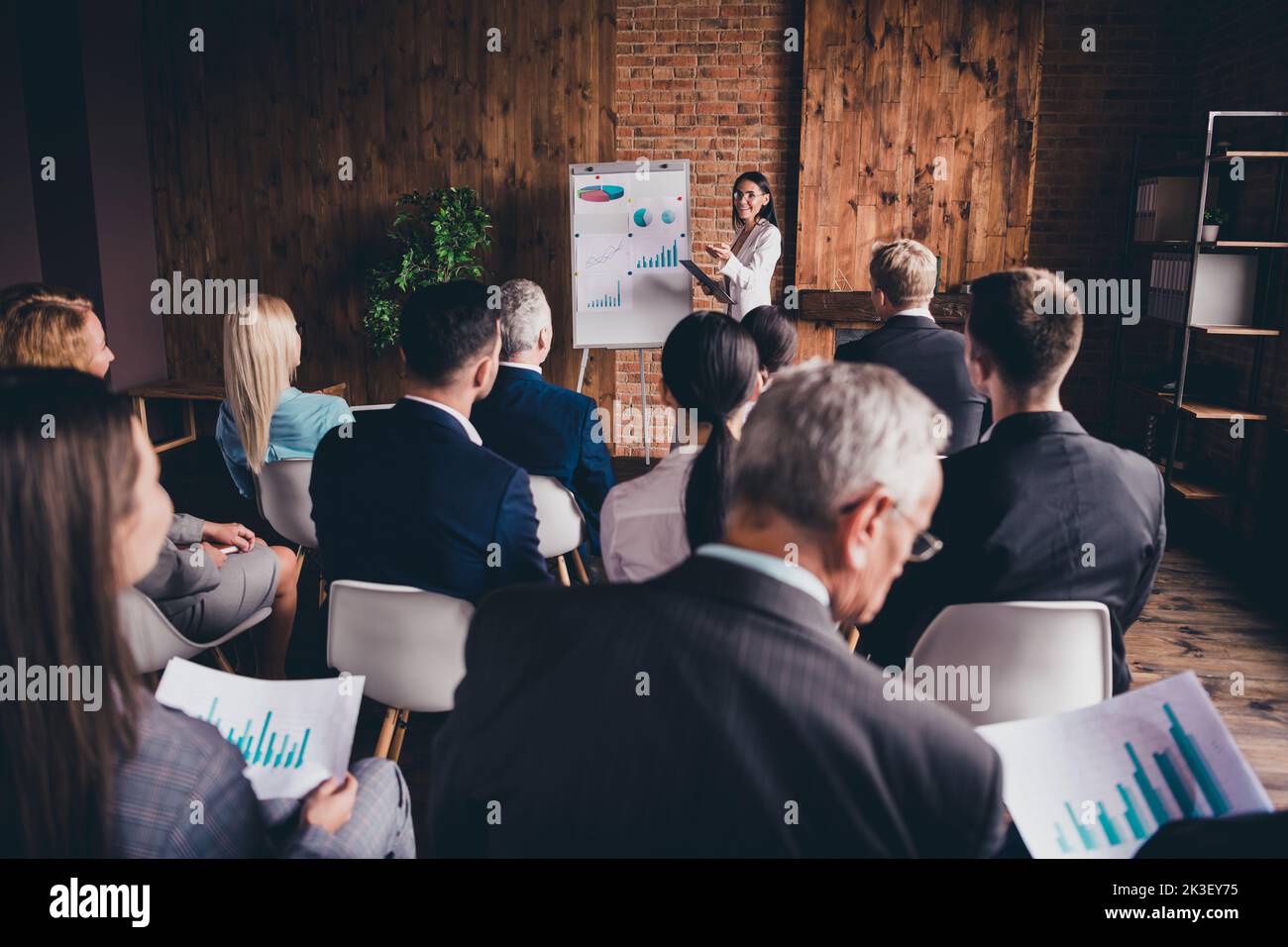 Businesspeople attending business meeting listening to reporter ...