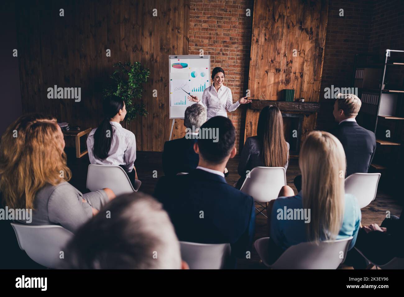 Portrait of successful business people sitting conference room listen ...