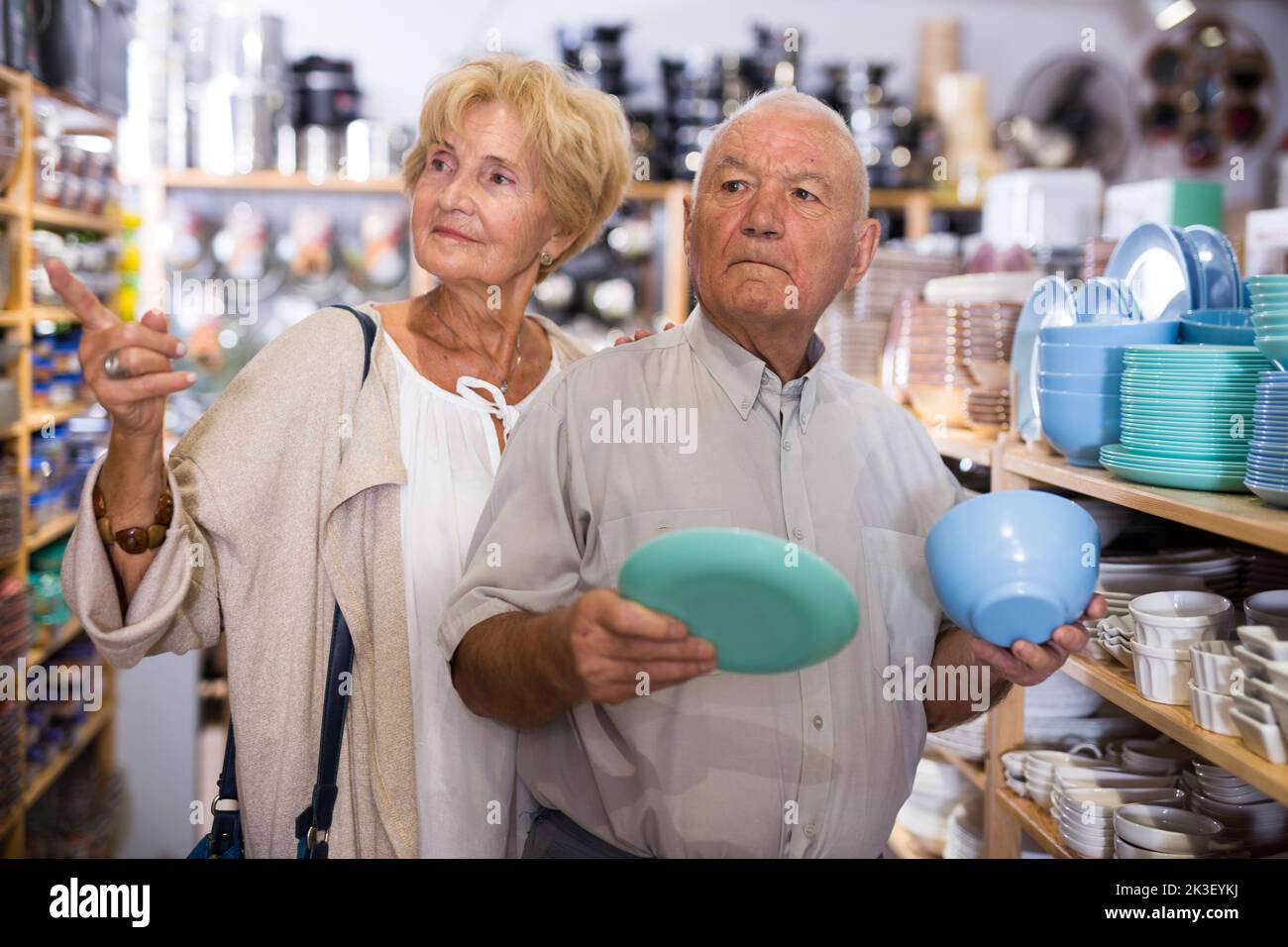 Couple elderly customers buying dishes Stock Photo - Alamy