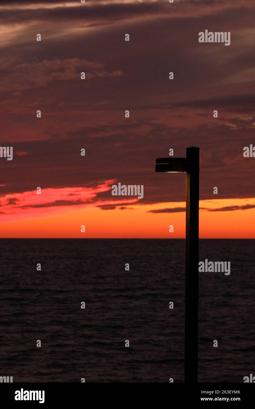 Street light in a red sunset scene Stock Photo - Alamy