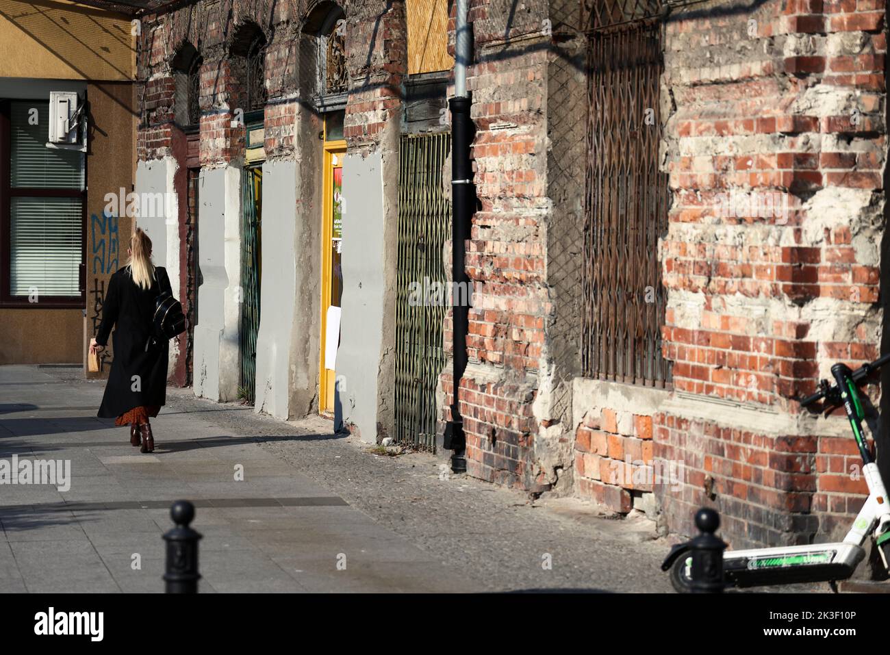 A woman walks past the Prozna 14 building in the last reaming part of ...