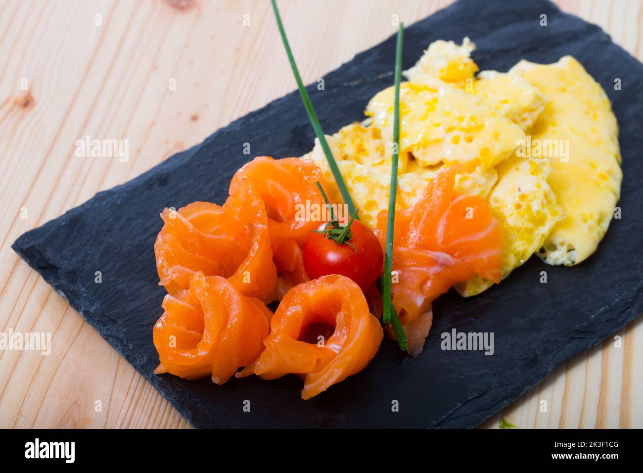 Traditional dish of Norwegian cuisine of omelet with salmon at plate ...