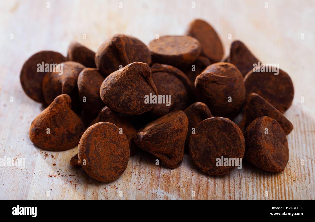 Dessert truffles sprinkled with cocoa on wooden table Stock Photo - Alamy