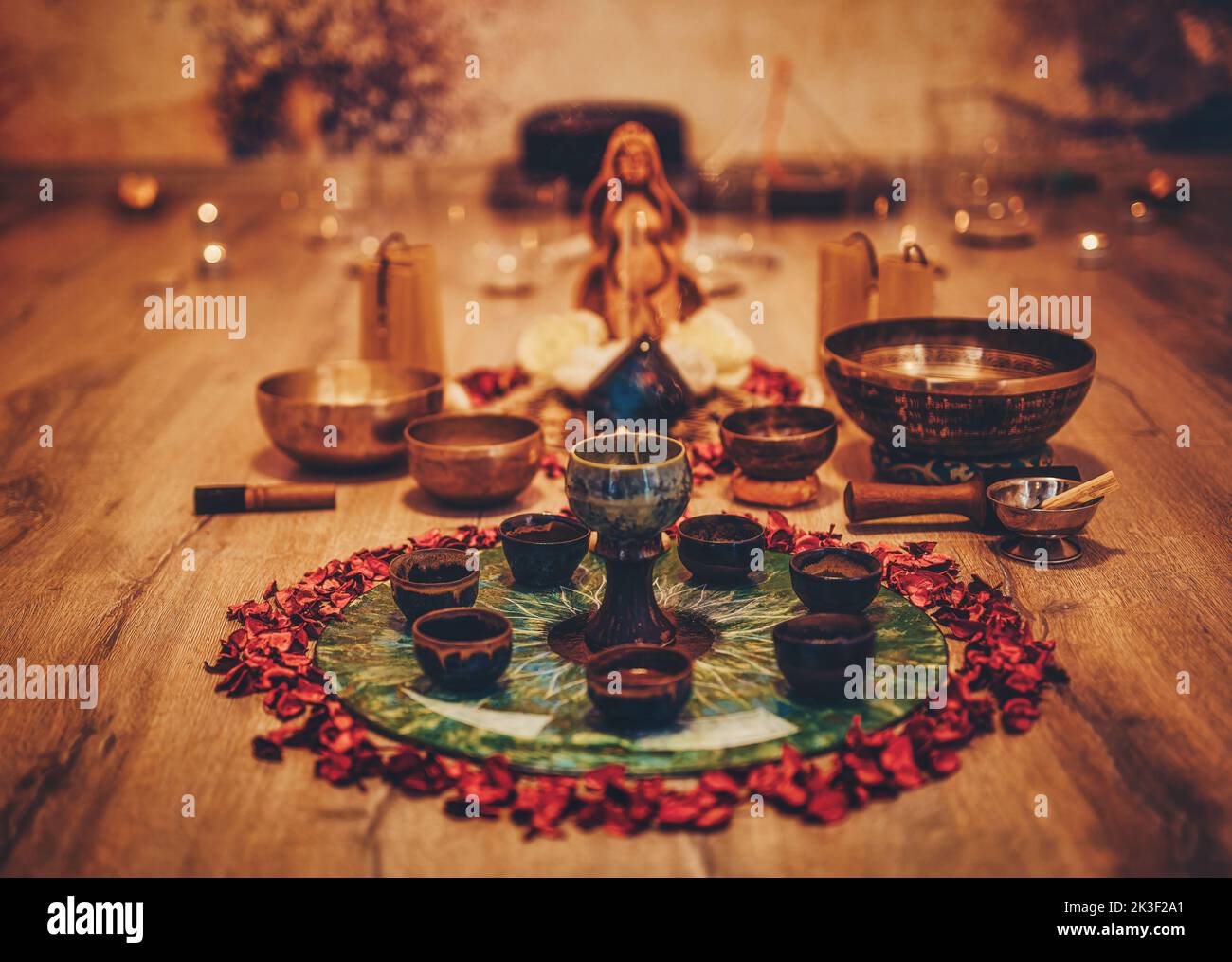 Beautiful altar with rose petals and goddess statuette. ceremony space ...