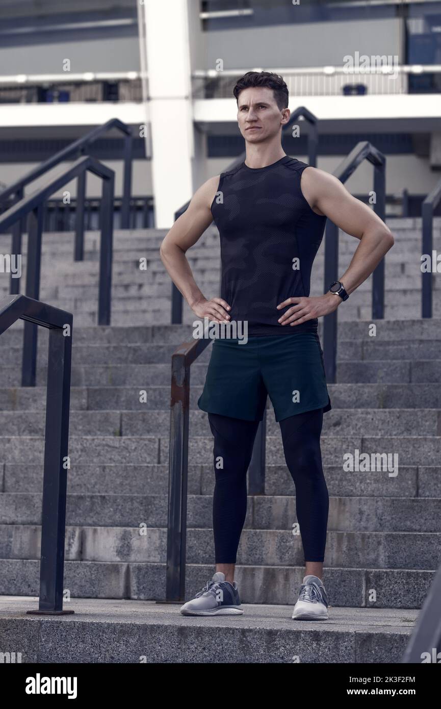 Focused on goal, concentrated handsome sportsman on stairs Stock Photo ...