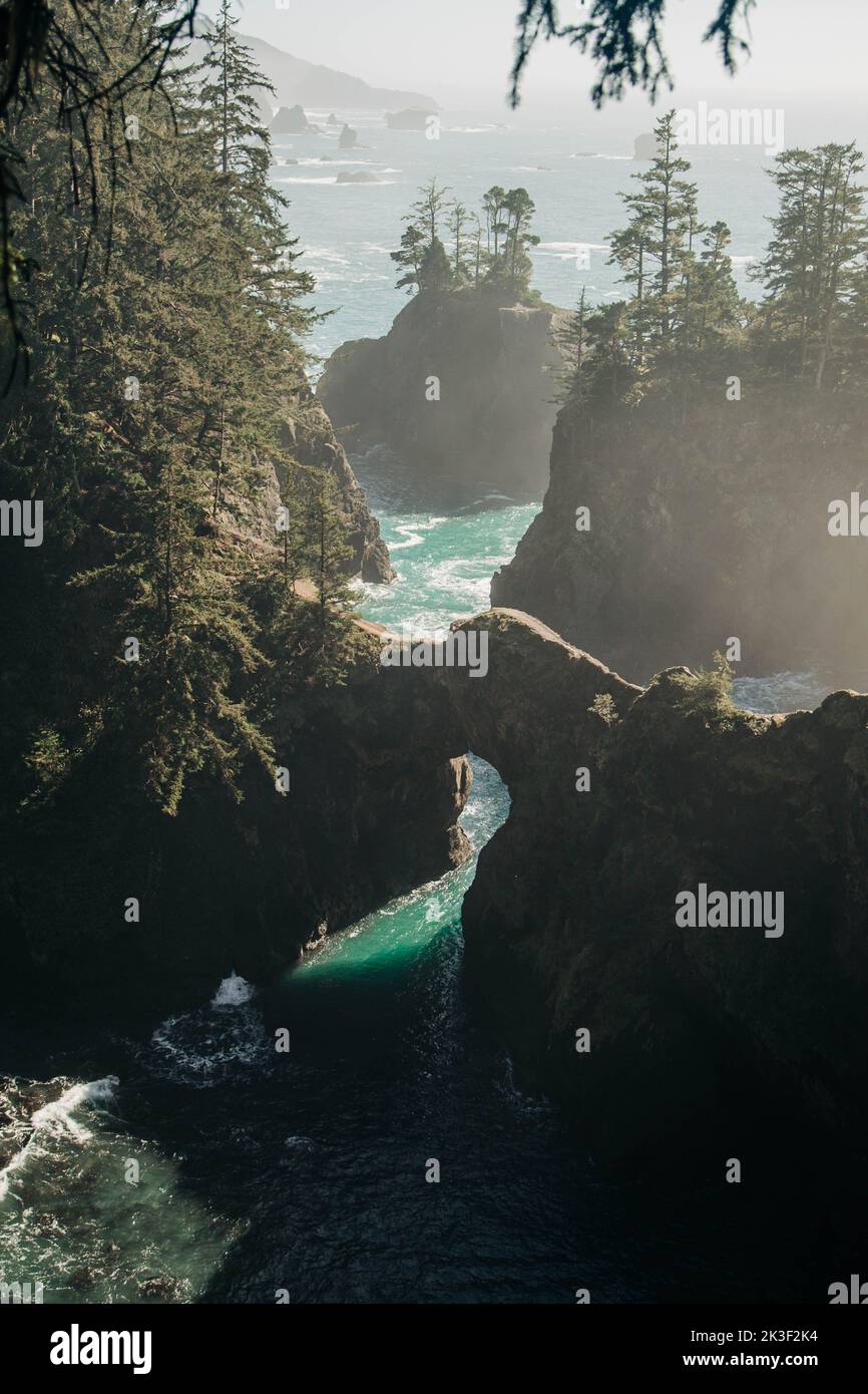 Overlooking an ocean arch in the Pacific Northwest on a warm dreamy day ...