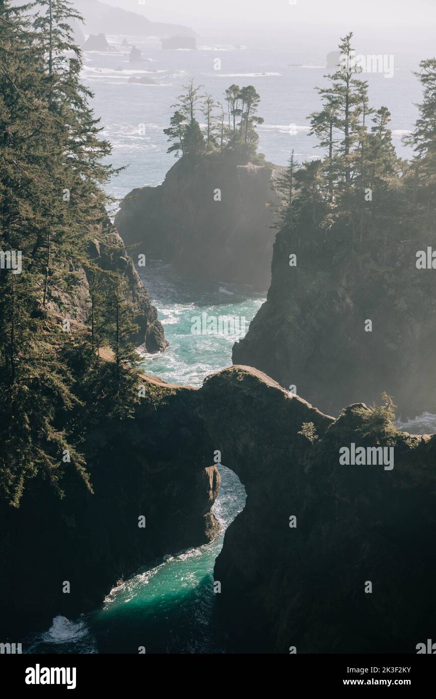 Overlooking an ocean arch in the Pacific Northwest on a warm dreamy day ...