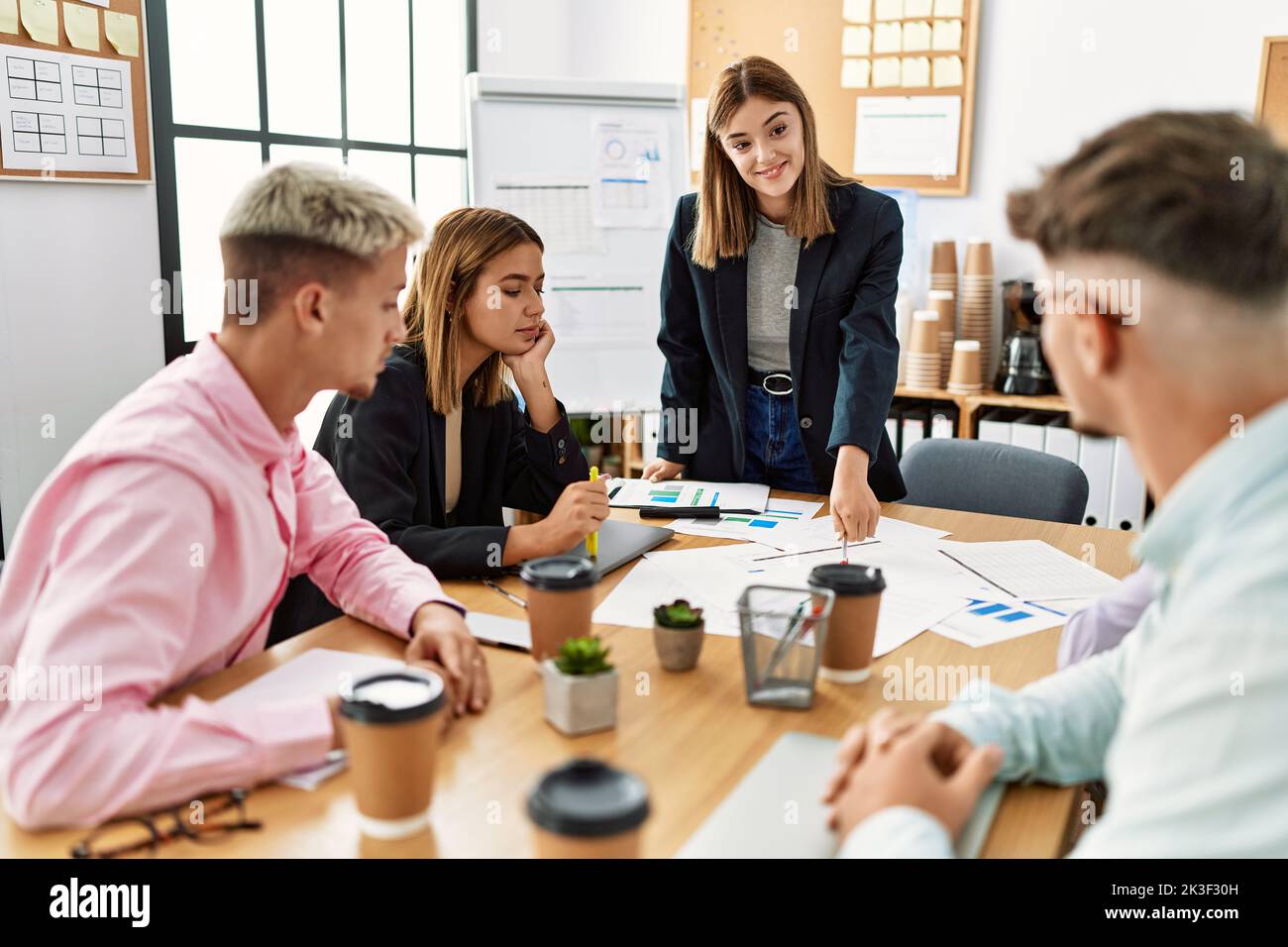 Group of business workers listening hispanic boss woman conference at ...