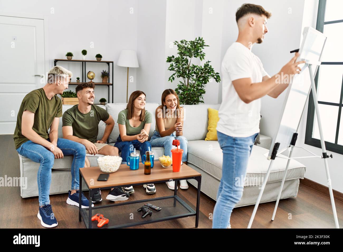 Group of young friends smiling happy playing game at home Stock Photo ...