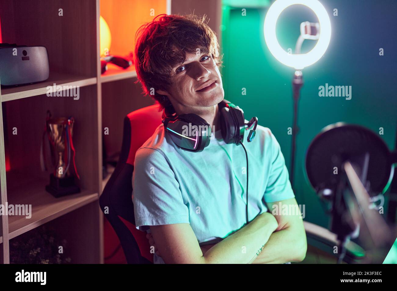 Young blond man streamer smiling confident sitting with arms crossed ...