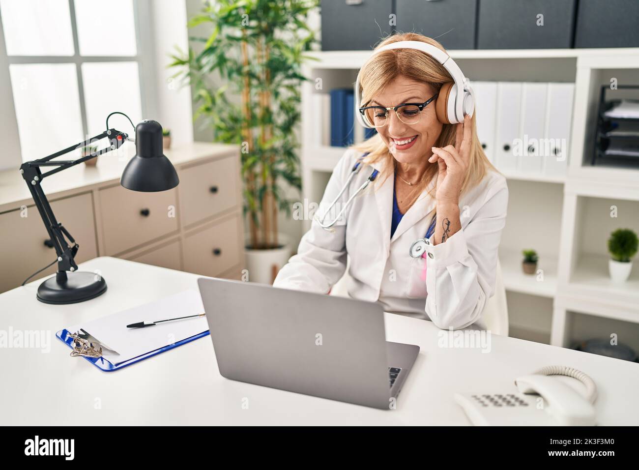 Middle age blonde woman wearing doctor uniform having medical ...