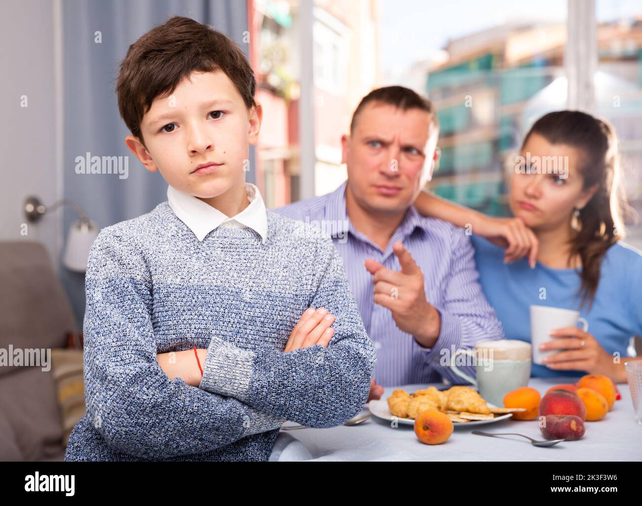Upset boy scolded by mother and father Stock Photo - Alamy