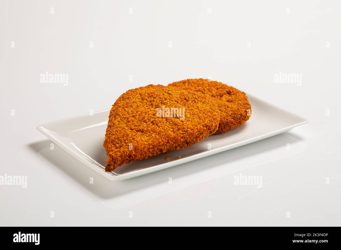 chicken cutlet with herbs on a white plate Stock Photo - Alamy