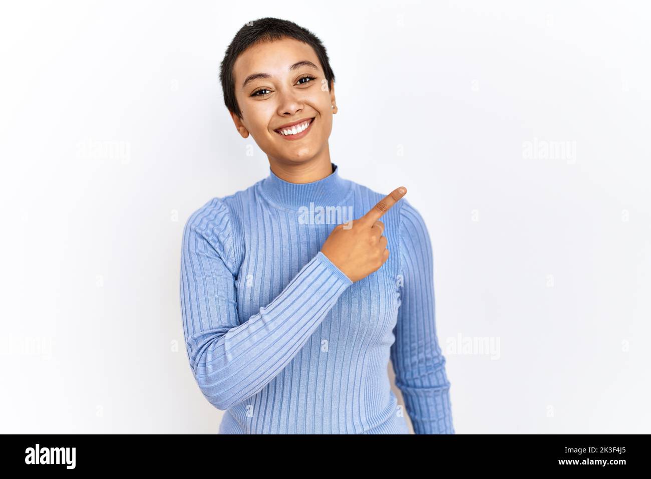 Young hispanic woman with short hair standing over isolated background ...