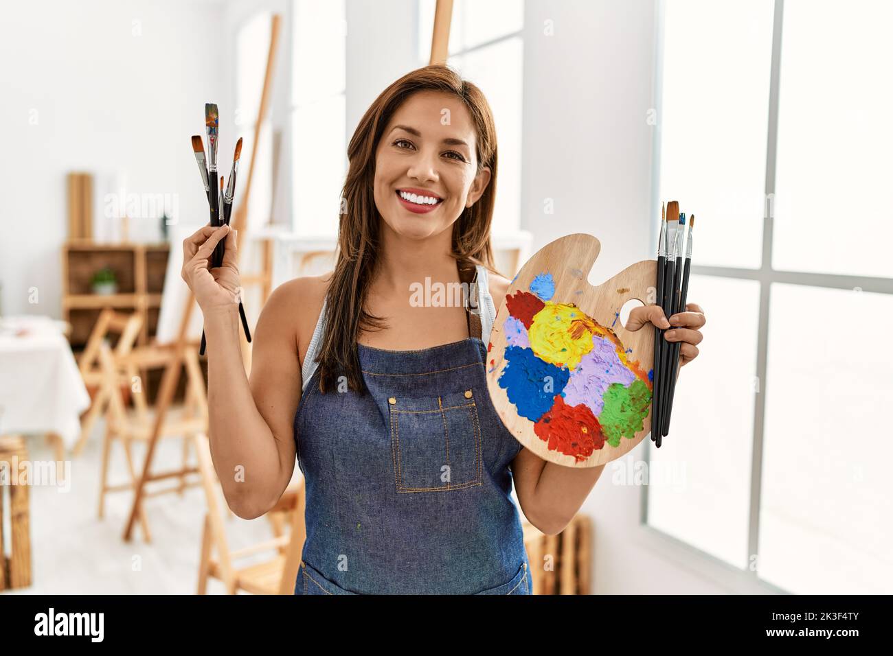 Young hispanic artist woman smiling happy drawing at art studio Stock ...