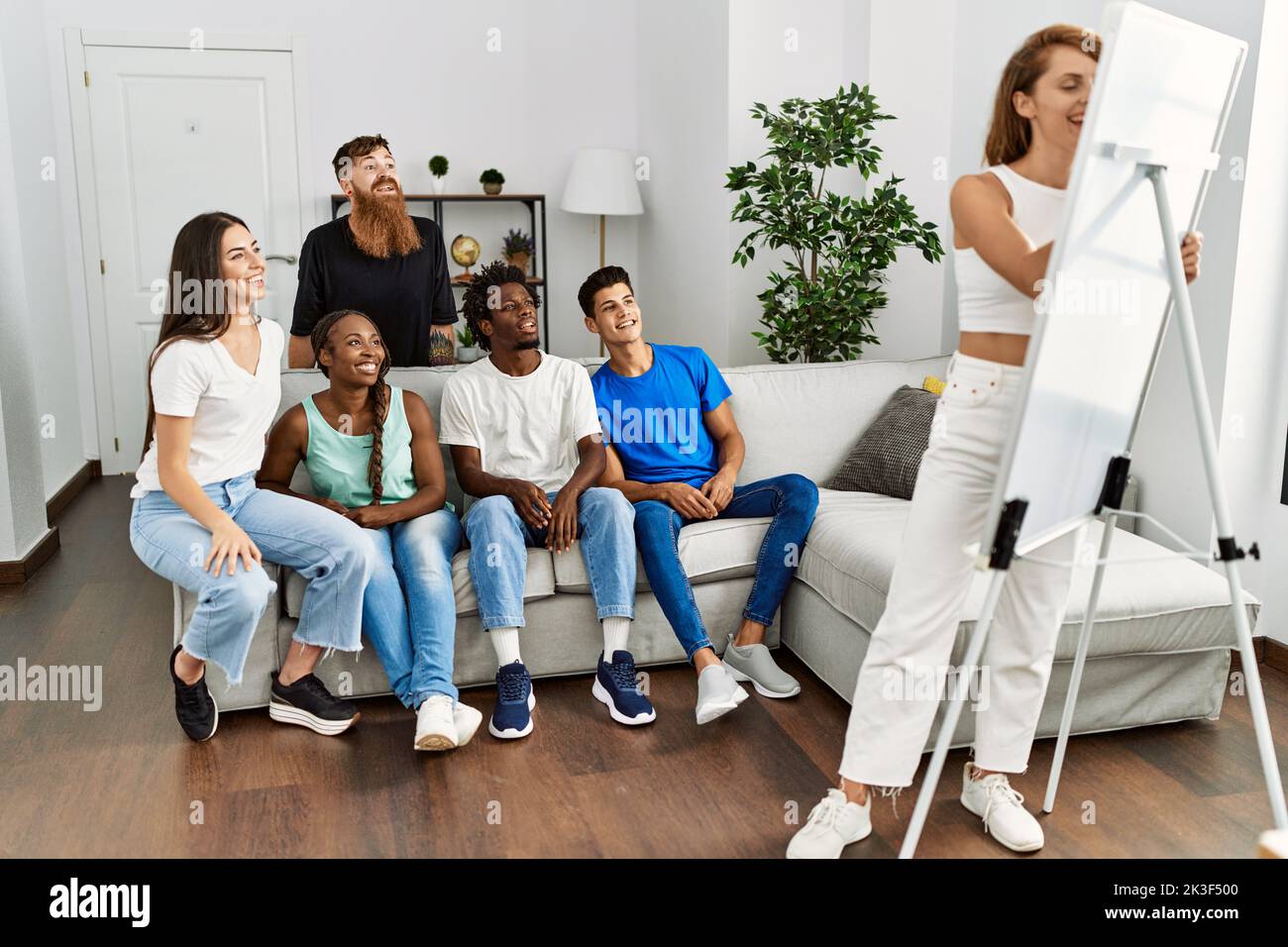Group of young friends smiling happy playing drawing game at home Stock ...