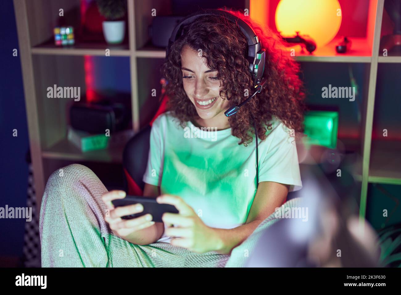 Young beautiful hispanic woman streamer playing video game using ...