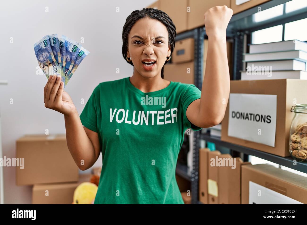 Young african american woman wearing volunteer t shirt holding african ...