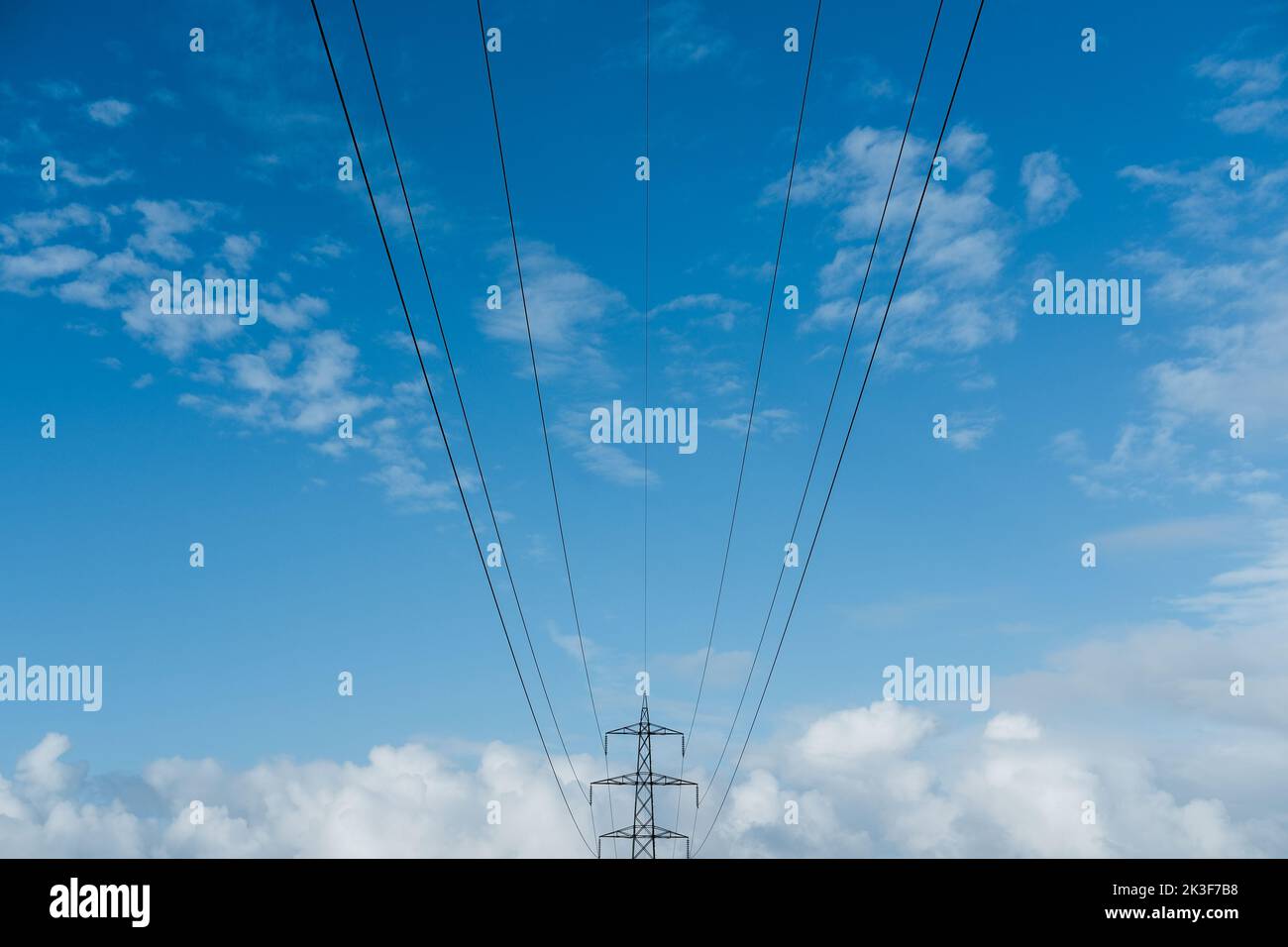 High-voltage power line with clouds. High voltage electric transmission ...
