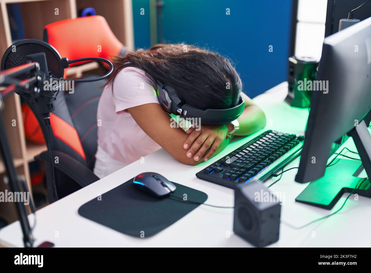 Young beautiful hispanic woman streamer stressed using computer at ...