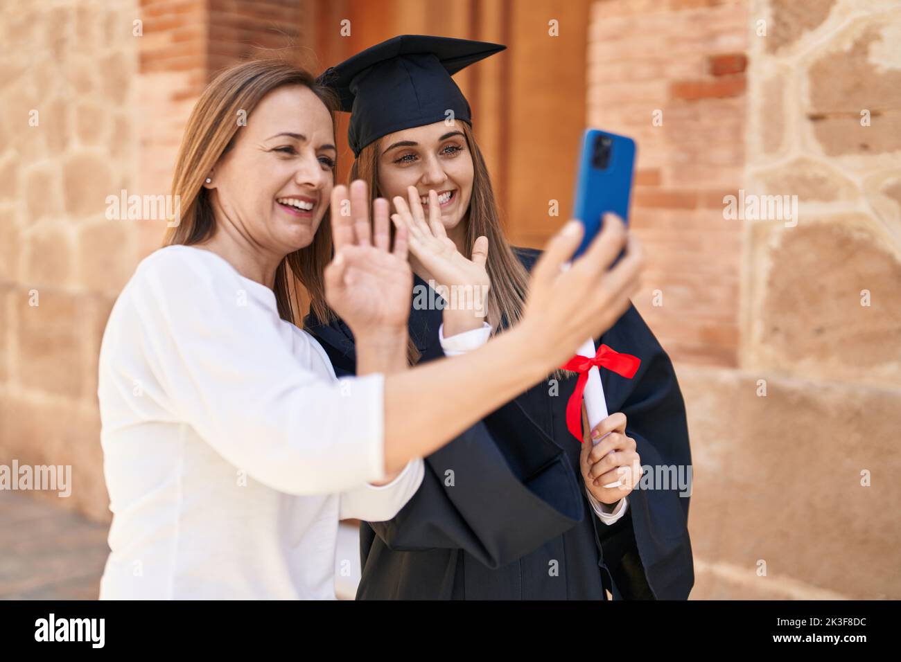 Two Women Mother And Graduated Daughter Having Video Call At Campus
