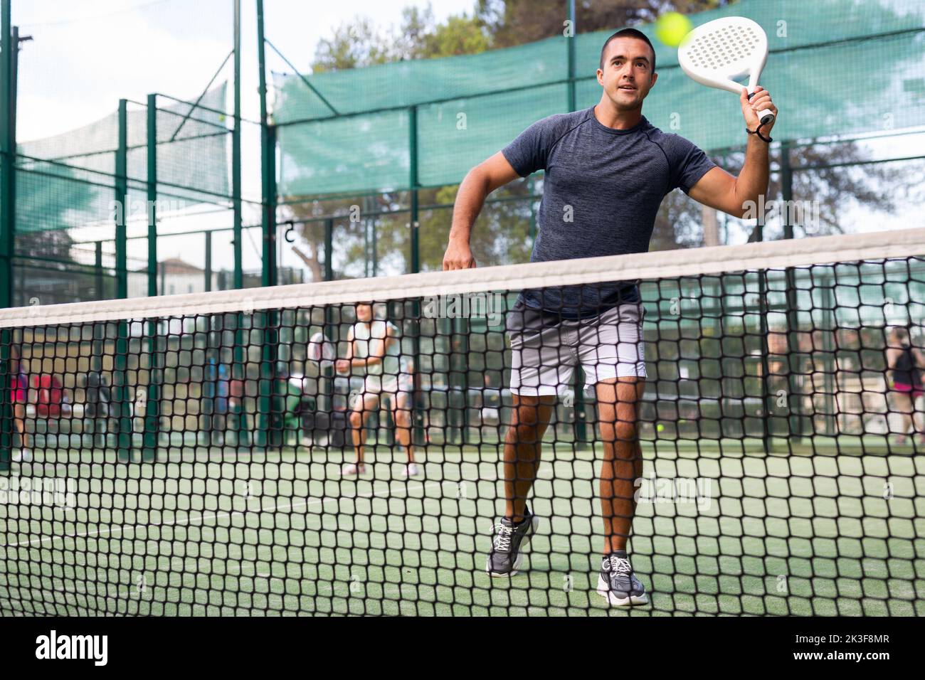 Man playing padel tennis on court Stock Photo - Alamy