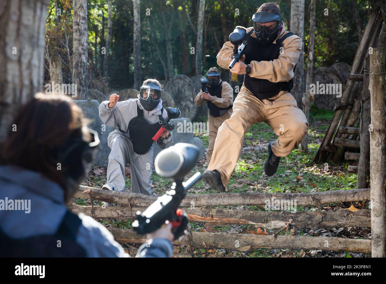 People playing paintball outdoors Stock Photo - Alamy