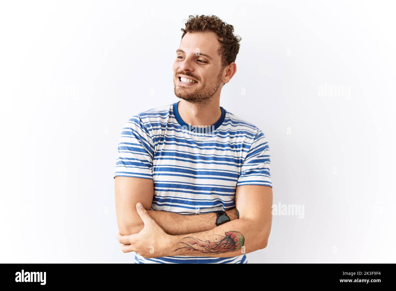Handsome young man standing over isolated background looking away to ...